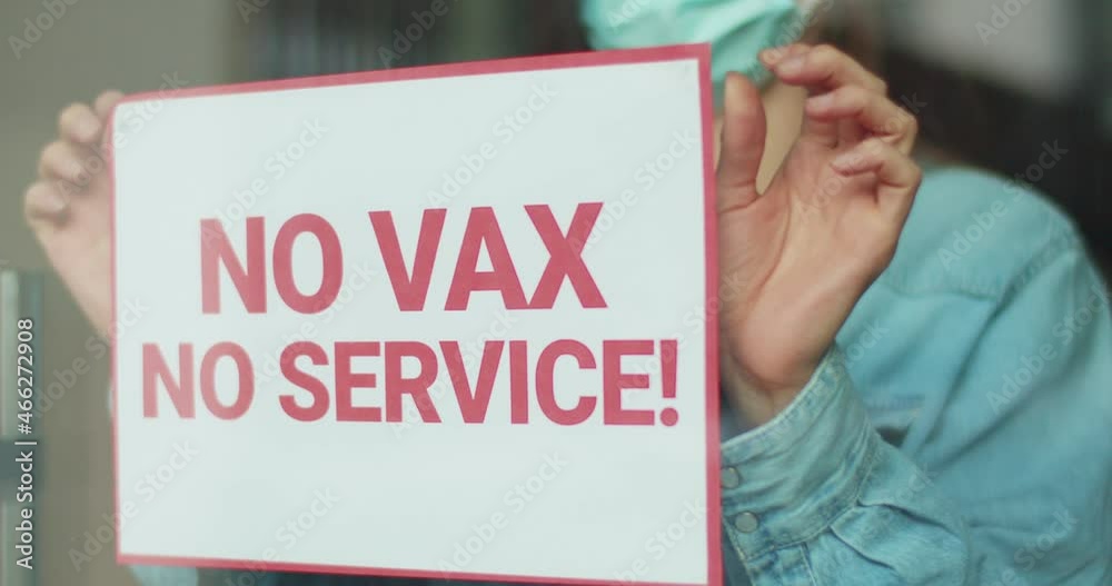 Close up of woman hands attaching sign on the glass in pandemic time ...