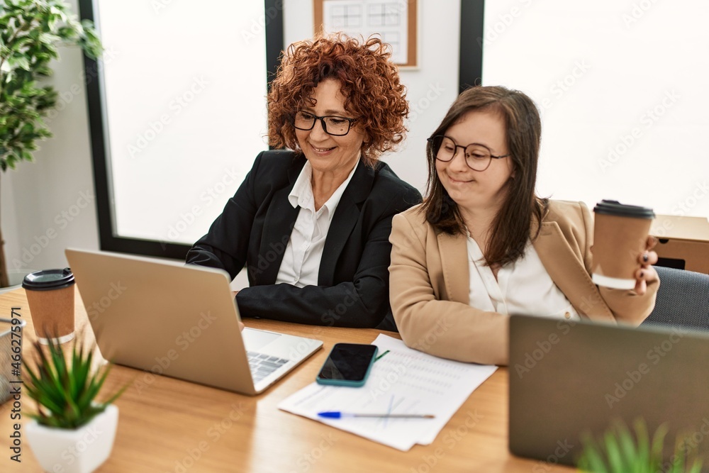 Group of two women working at the office. Mature woman and down ...