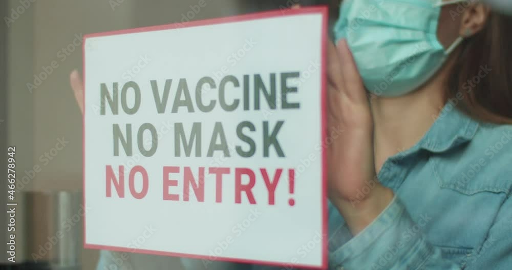 Close up of womans hands attaching sign on the glass in pandemic time ...