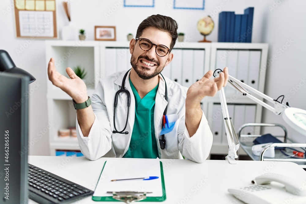 Young man with beard wearing doctor uniform and stethoscope at the ...