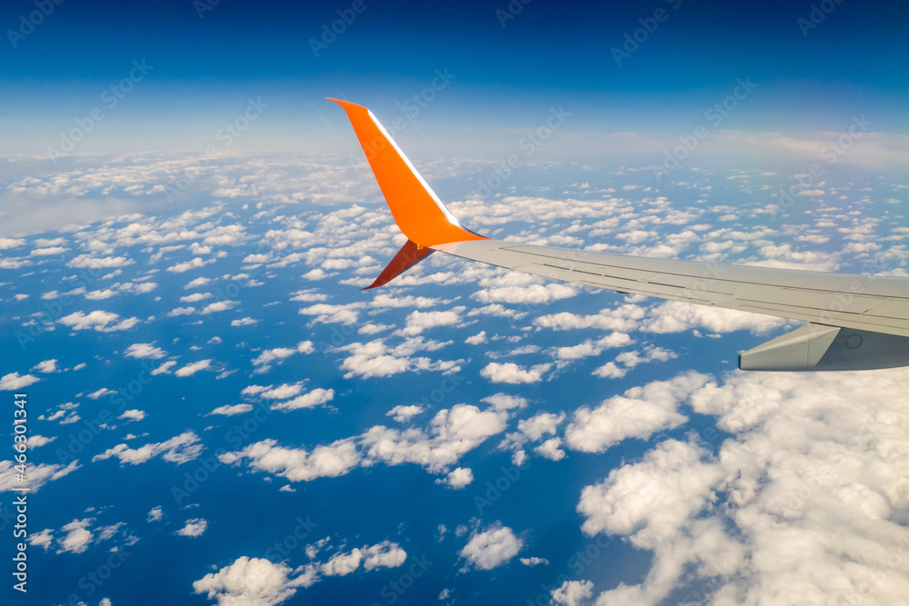 Breathtaking view. The wing of a small scheduled plane against the blue ...
