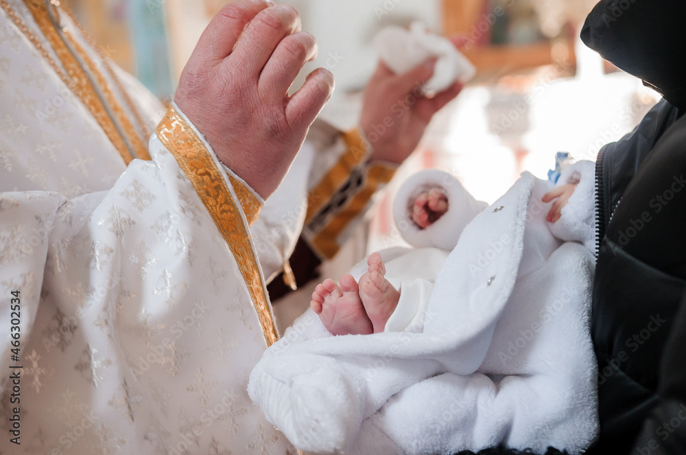 sacrament of baptism the priest baptizes the child with the anointing ...