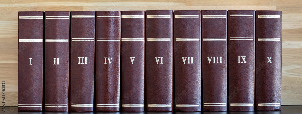 Ten book volumes in row. Roman numerals on hardback book spine. Home ...