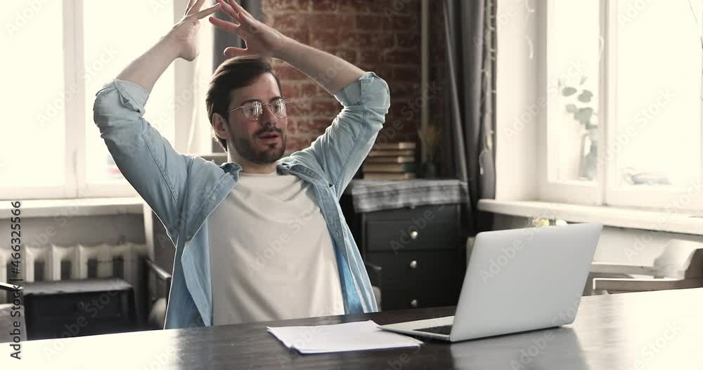 Young satisfied businessman office employee finish work on laptop ...