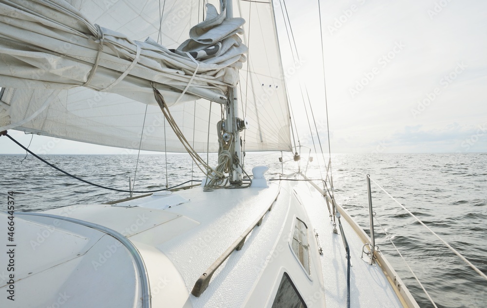 White yacht sailing in an open sea on a sunny summer day. Close-up view ...