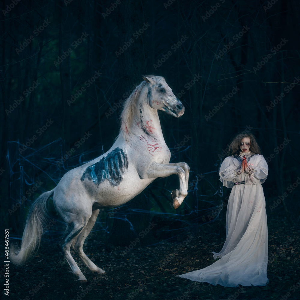 Woman in a ghost dress and a dead white horse on its hind legs in the ...