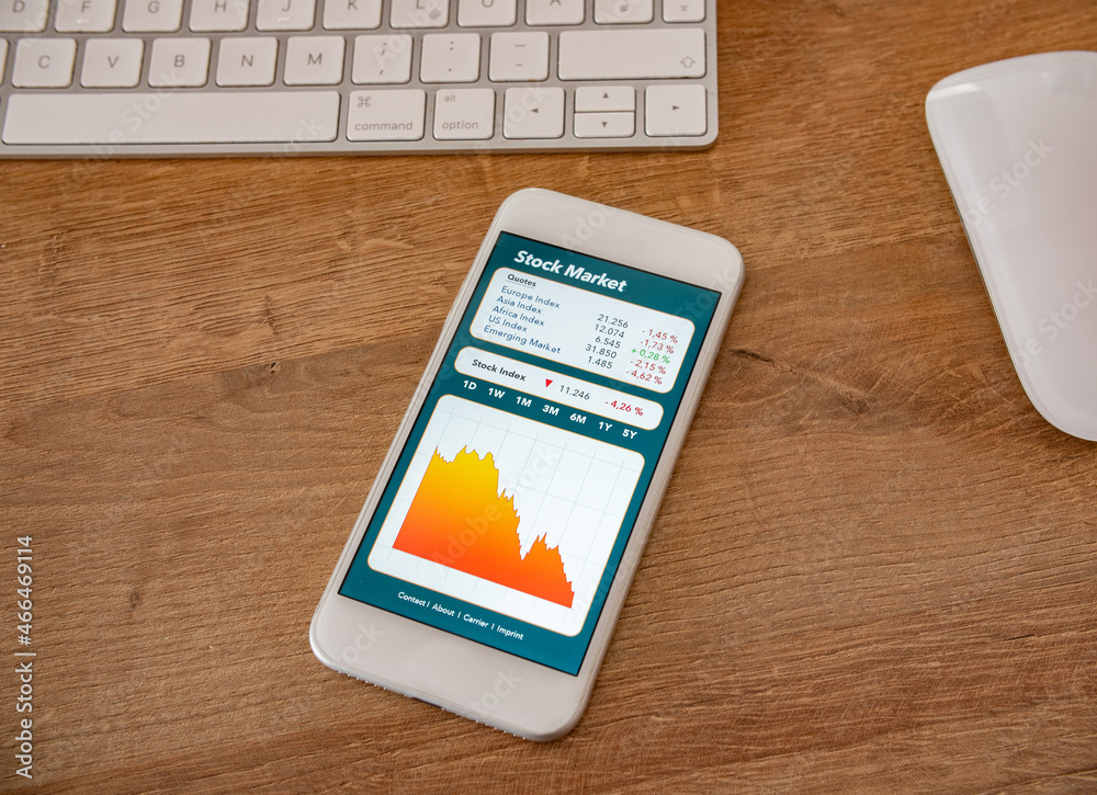 Mobile Phone on a desk shows continent stock indexes like Africa ...