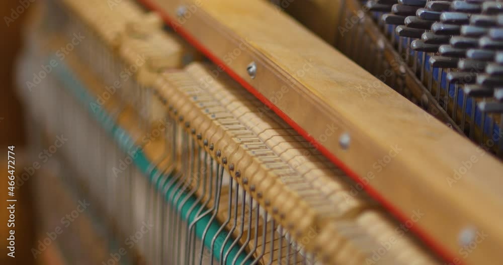 The hammers of a beautiful wooden grand piano form a chord melody ...