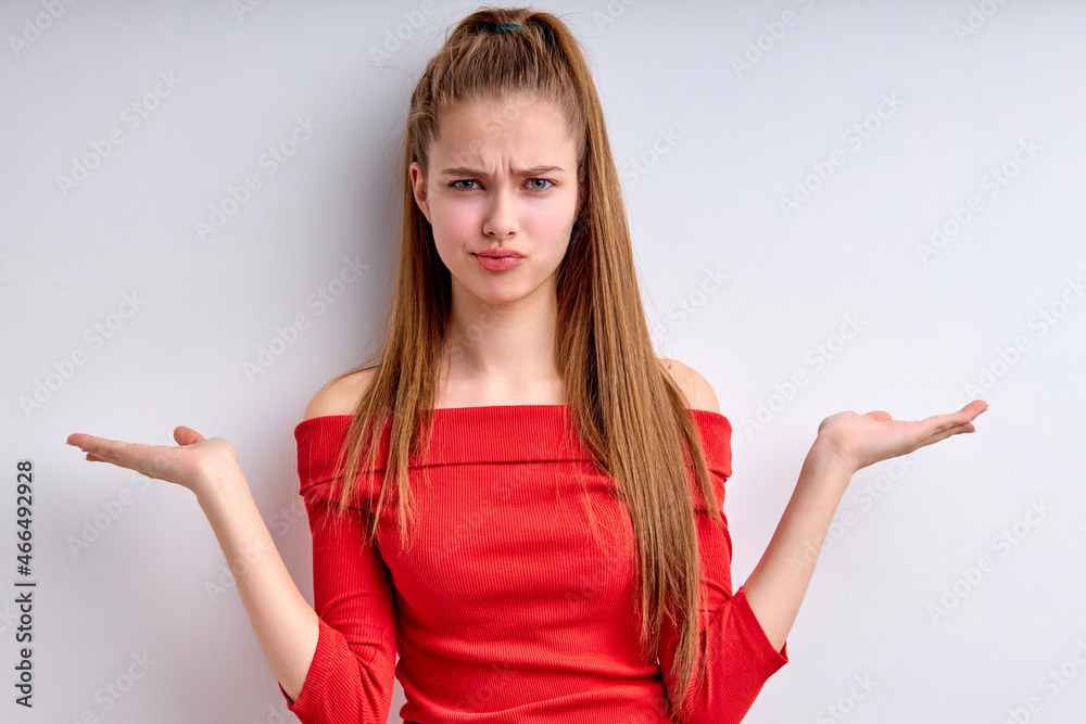 Puzzled young teen girl with distrustful face raising hands up ...
