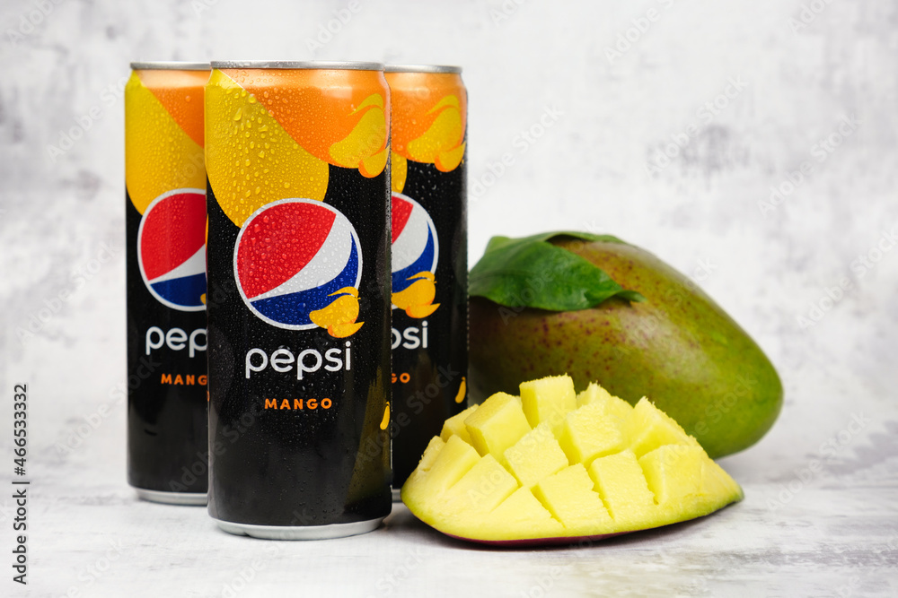 Three cans of pepsi drink with mango flavor and mango fruit. Expanding ...
