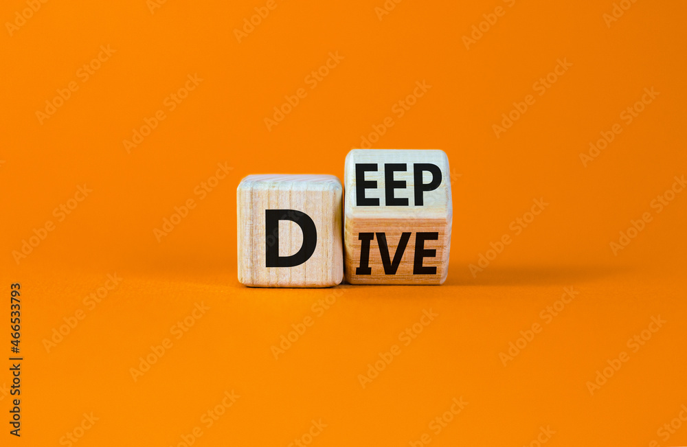Deep dive symbol. Turned a wooden cube with words 'Deep dive ...