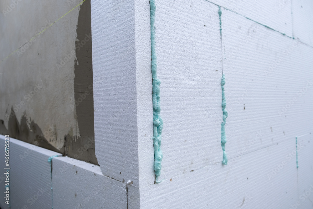 Installation of styrofoam insulation sheets on house facade wall for ...