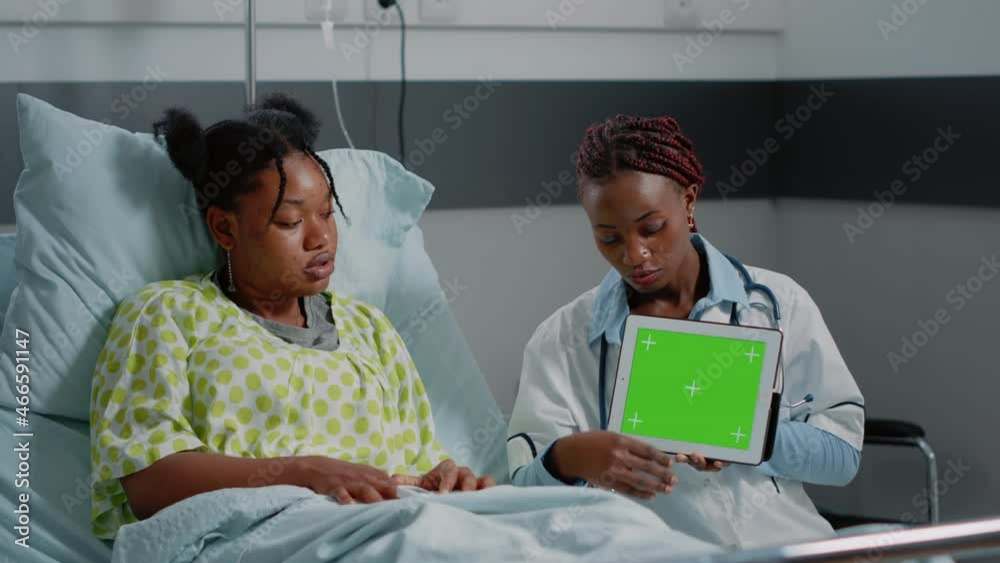 Physician holding digital tablet with horizontal green screen, showing ...