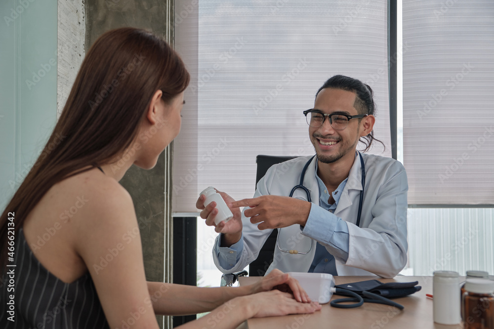 Medical treatment and check-up, young male doctor talks with a smile ...