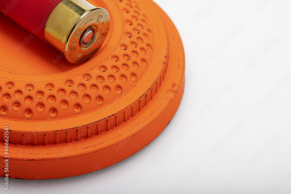 Clay disc flying targets and shotgun bullets on white background ,Clay ...