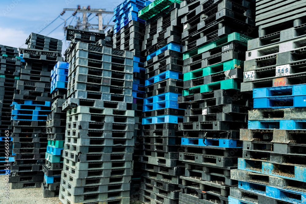 Pile of plastic shipping pallet. Industrial plastic pallet stacked at ...