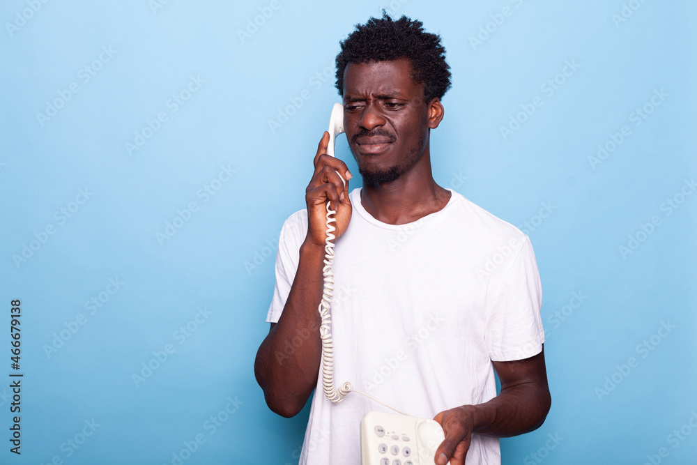 Man answering retro landline phone while posing. Young person with ...