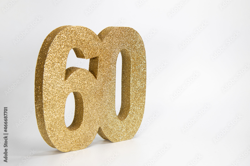 A gold glittery sign that says the number 60 on a white background ...