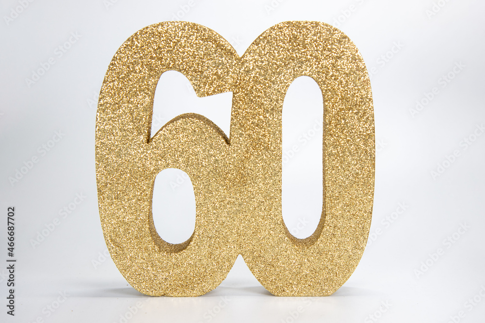 A gold glittery sign that says the number 60 on a white background ...