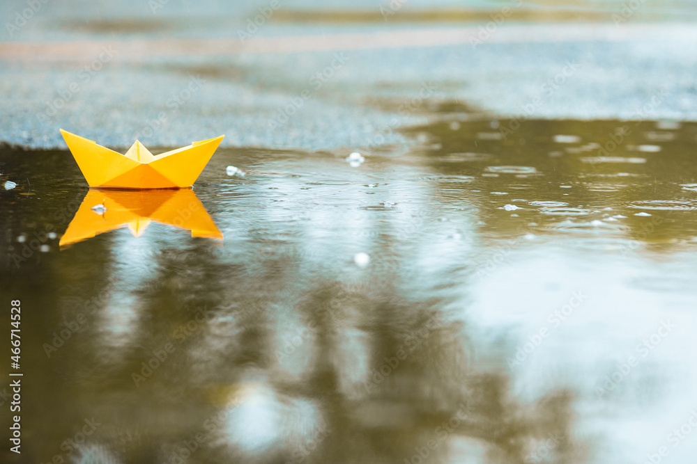 Paper handmade boat toy on a puddle in a rain. Creed hope and chilhood ...
