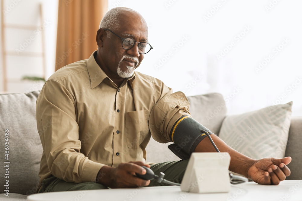 Senior Black Man Measuring Arterial Blood Pressure At Home Stock Photo ...