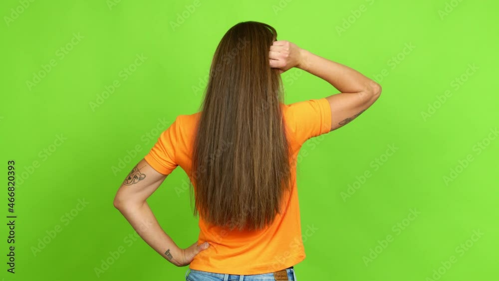 Young blonde girl on back position looking back while scratching head ...