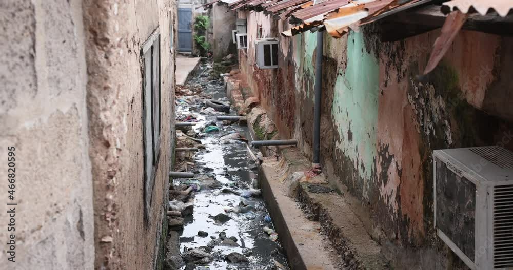Alley between homes raw sewer ditch Accra Ghana. Historical busy ...