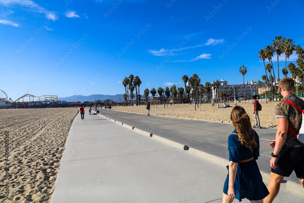 Stockfoto people walking and riding bikes and skateboards down a smooth ...