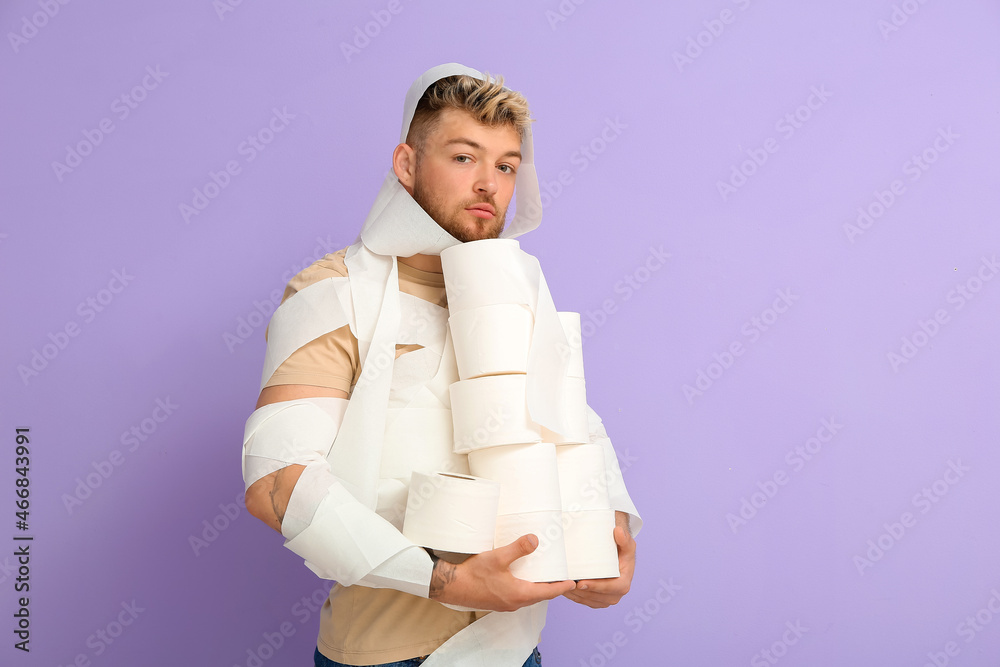 Funny young man wrapped in toilet paper on color background Stock Photo ...