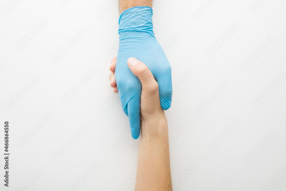 Doctor hand in rubber glove shaking adult woman hand on white ...
