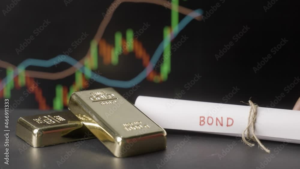 Concept of gold bond showing with Gold bars and Bond paper placing next ...