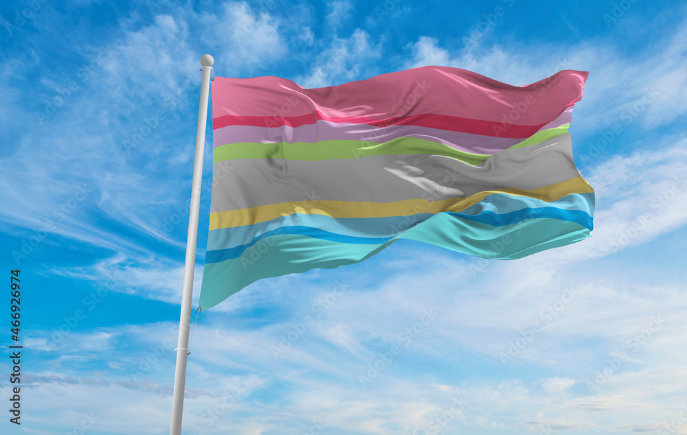 flag of Gender questioning waving in the wind at cloudy sky. Fre Stock ...