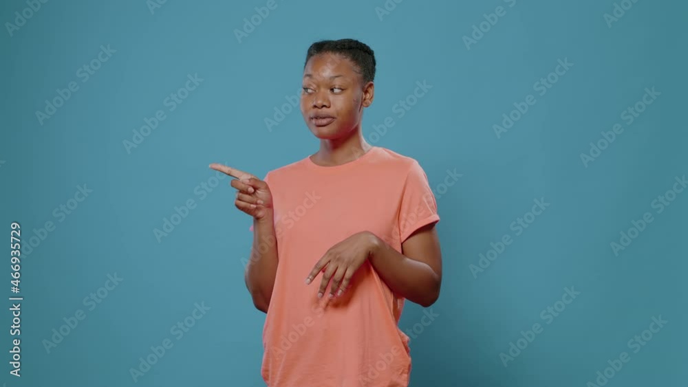 Young adult indicating left and right direction with hands, standing ...