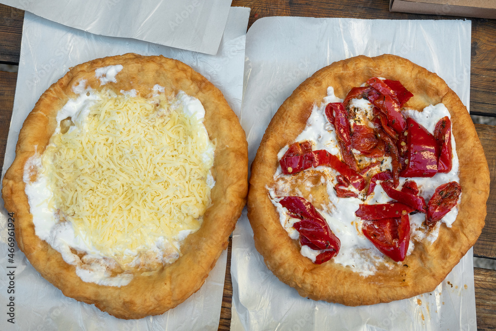 Langos with different toppings on wooden table. Top view. Langos - deep ...