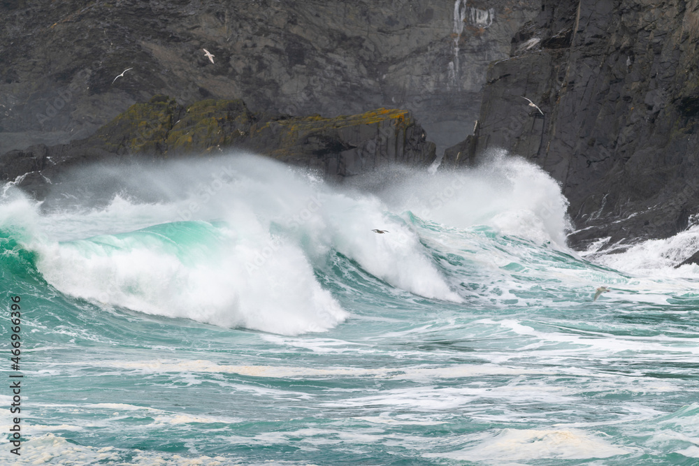 An angry turquoise green color massive rip curl of a wave as it rolls ...