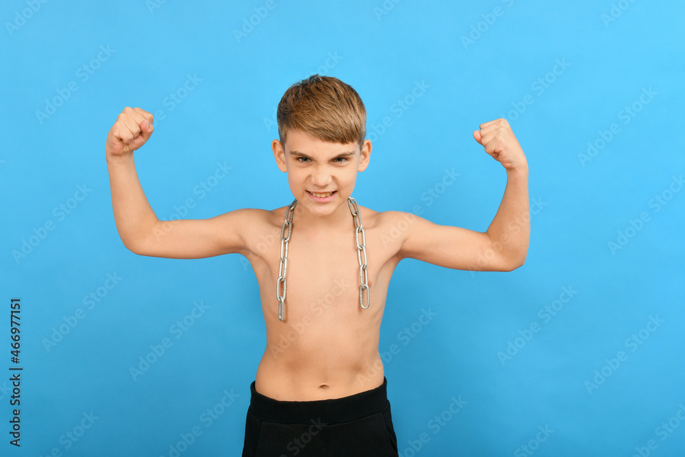 A small thin boy with a chain around his neck raised his arms to the ...
