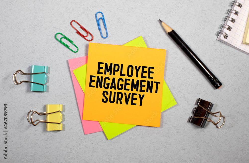 Employee Engagement Survey sign written on sticky note pinned on wooden ...