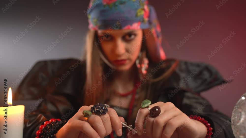 Scary young gypsy woman staring with her evil eyes spelling death ...