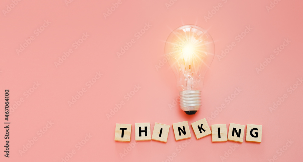 Light bulb with light flare, wooden cube block with alphabet text ...