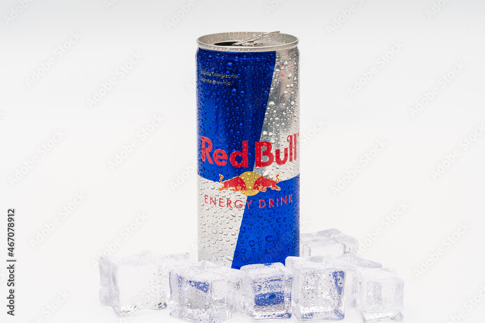Aluminium can of Red Bull Energy drink with ice and drops. Red Bull is ...