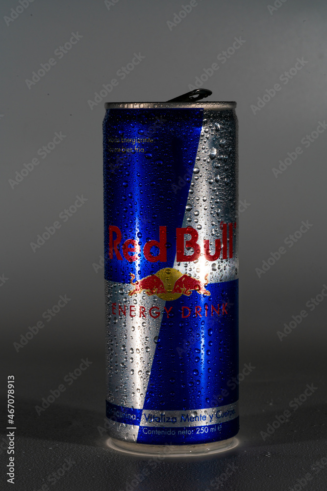Aluminium can of Red Bull Energy drink with ice and drops. Red Bull is ...