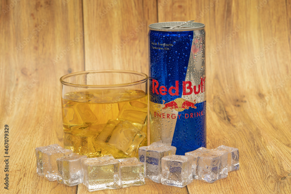 Aluminium can of Red Bull Energy drink with ice and drops. Red Bull is ...