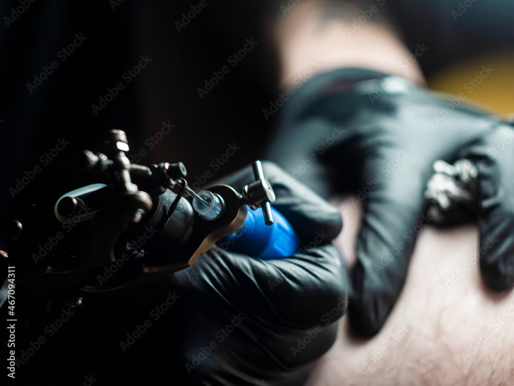 tattoo artist drawing a tattoo Stock Photo | Adobe Stock