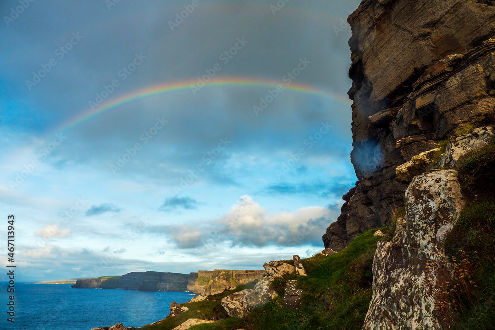Colorful rainbow in the ocean next to Cliff of Moher, county Clare ...