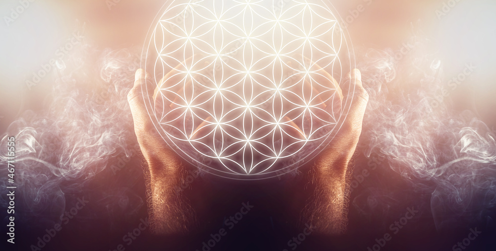 hand in smoke ona black background, praying hands and flower of life ...