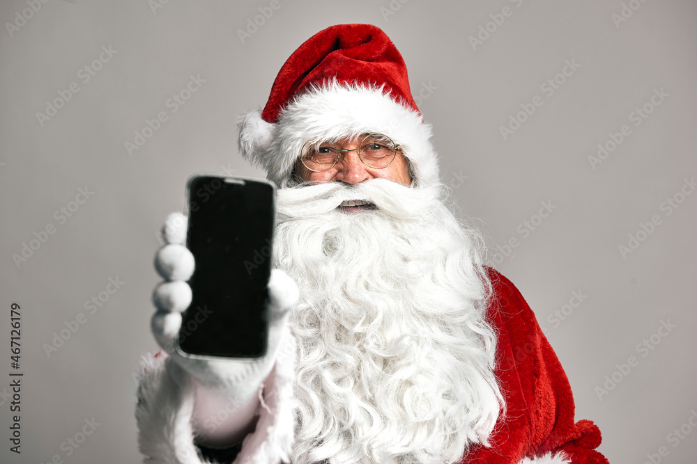 Santa Claus showing screen of mobile phone Stock Photo | Adobe Stock