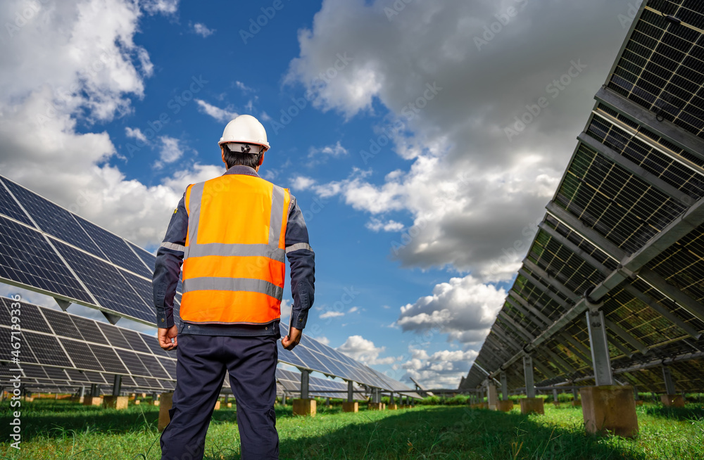 Technician dressed in blue uniform and in an orange reflective vest and ...