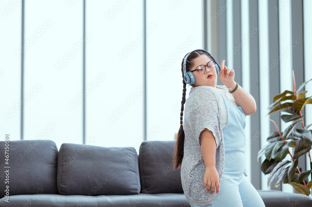 Autistic girl exercises and sings happily at home. Stock Photo | Adobe ...