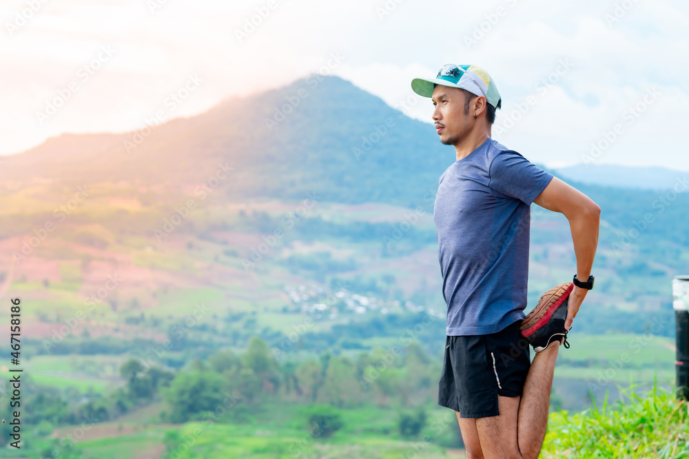 Half-body shot of an Asian male runner in a blue shirt and hat standing ...