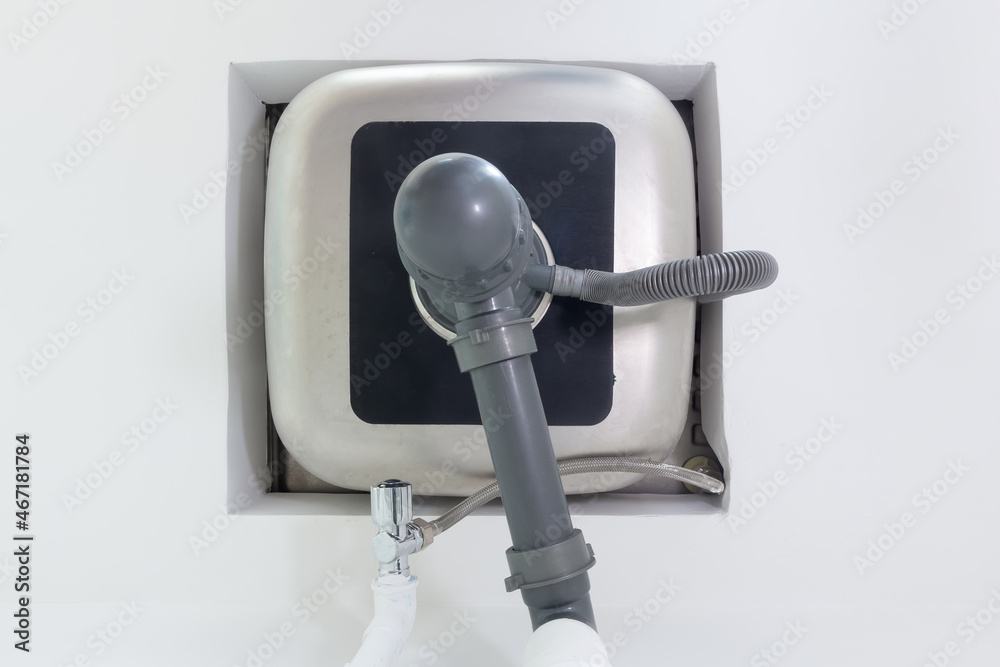 Drain pipe or sewer under kitchen sink. Pvc plastic pipe and flexible ...